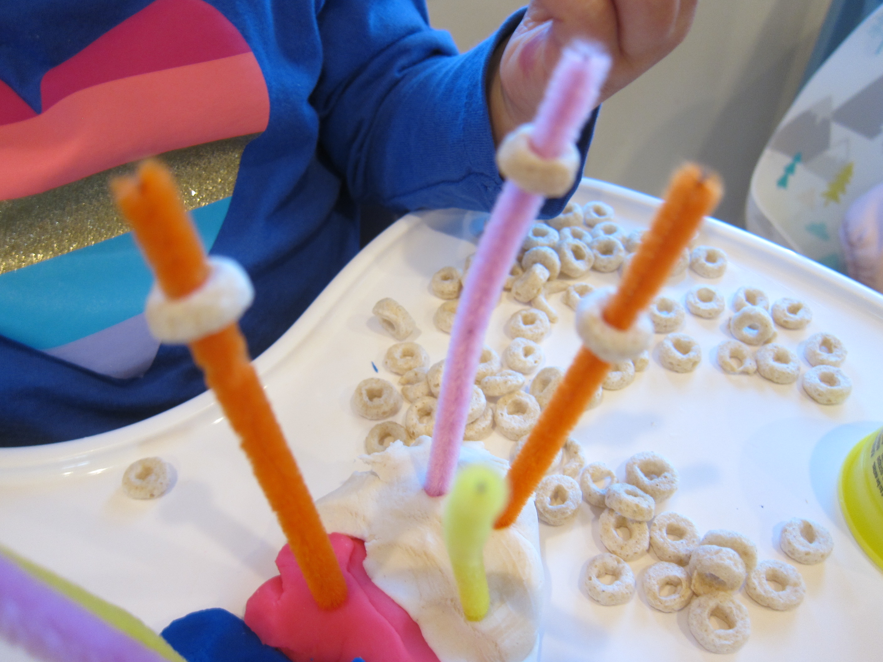 Threading Cereal on Pipe Cleaners – joyful parenting